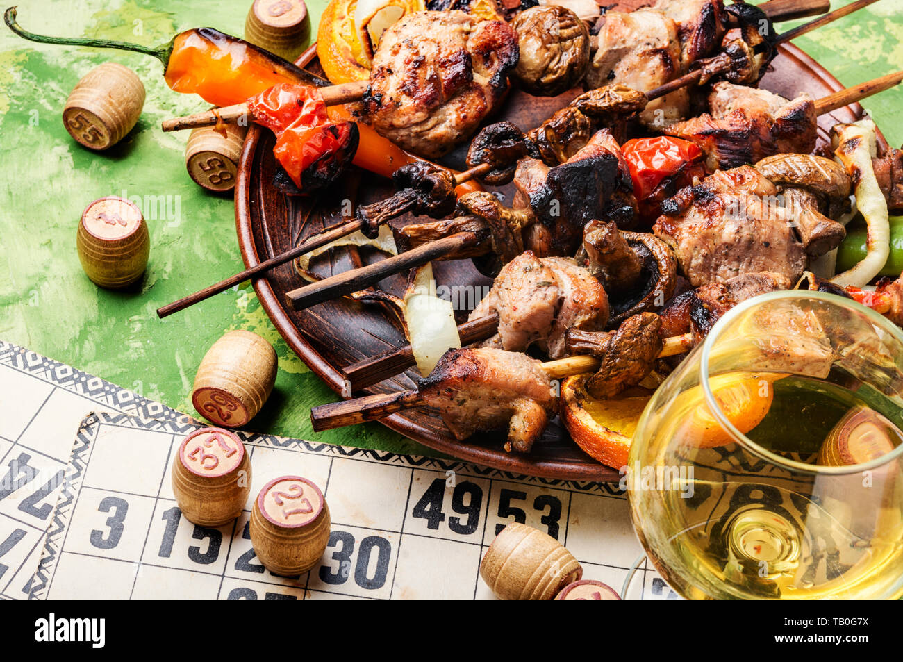 Summer picnic with shashlik and lotto board game.Barbecue and board ...