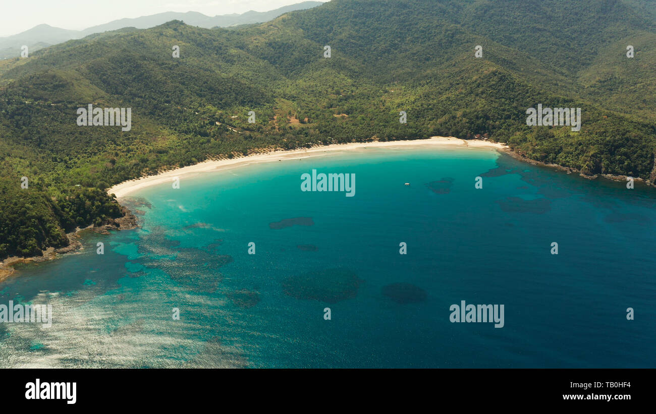 Aerial view beautiful tropical beach Nagtabon in the cove with blue ...