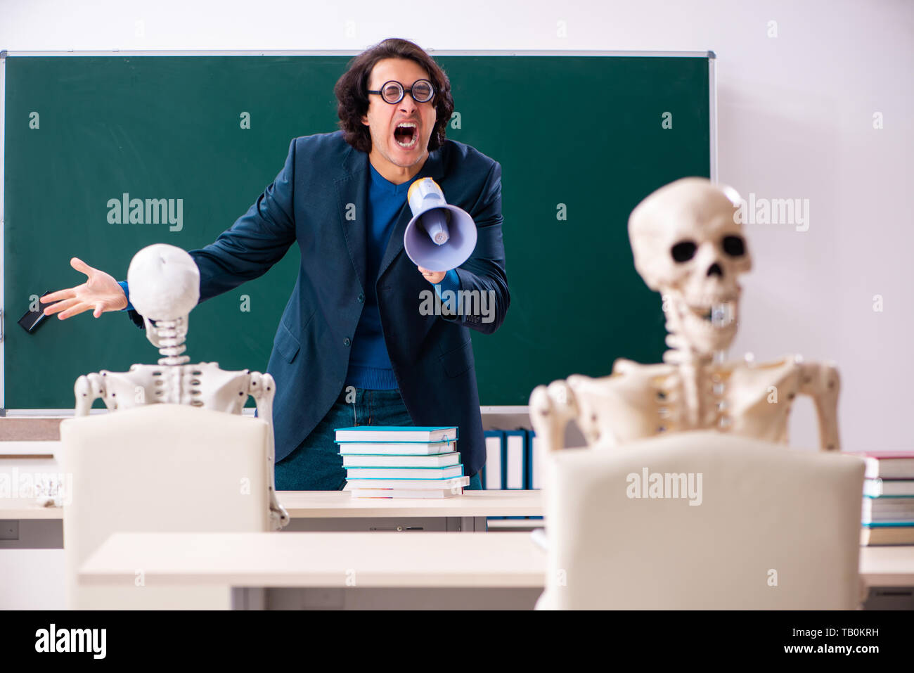 Male teacher and skeleton student in the classroom Stock Photo - Alamy