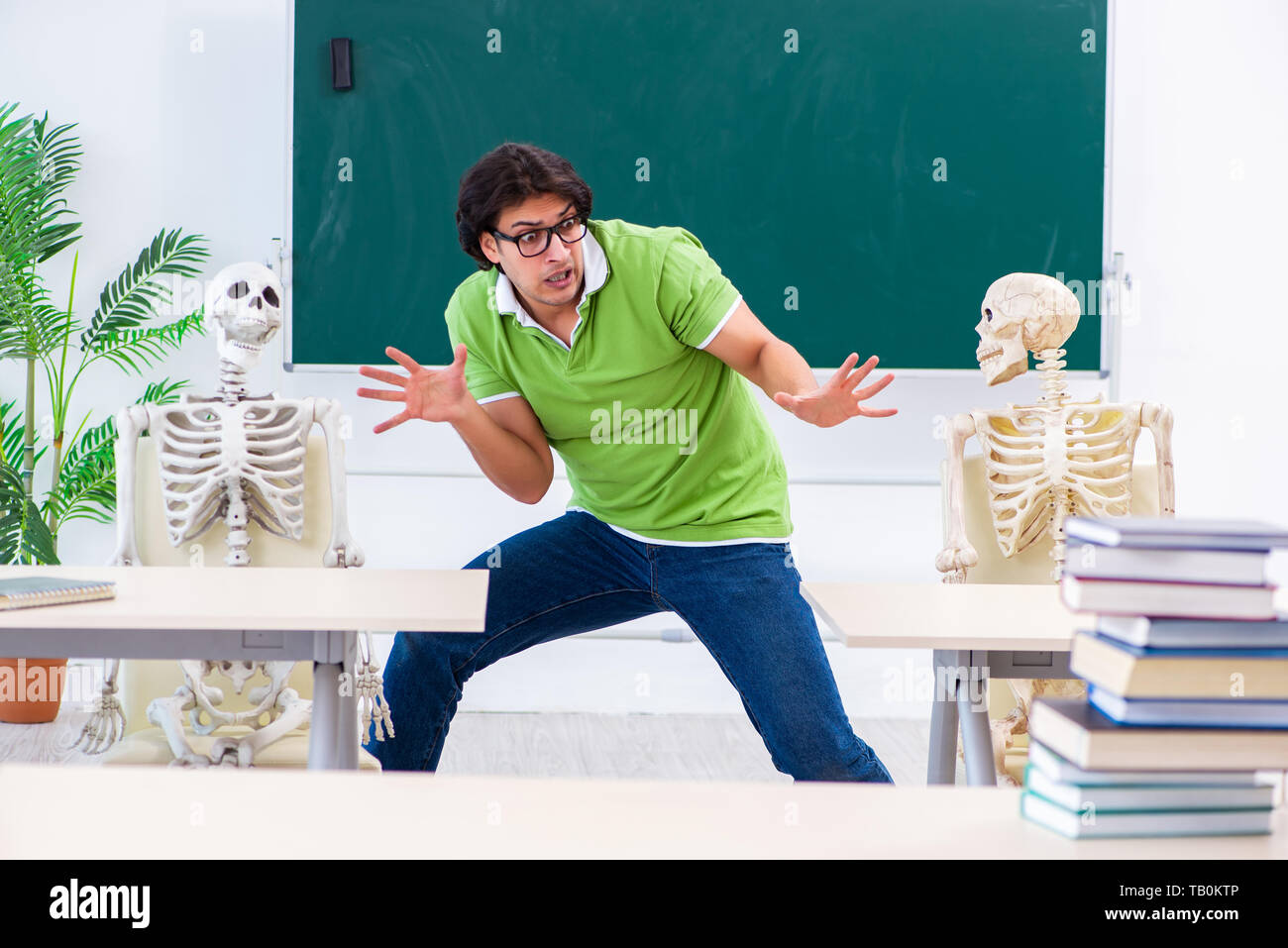 Funny male student in the classroom with skeleton Stock Photo - Alamy