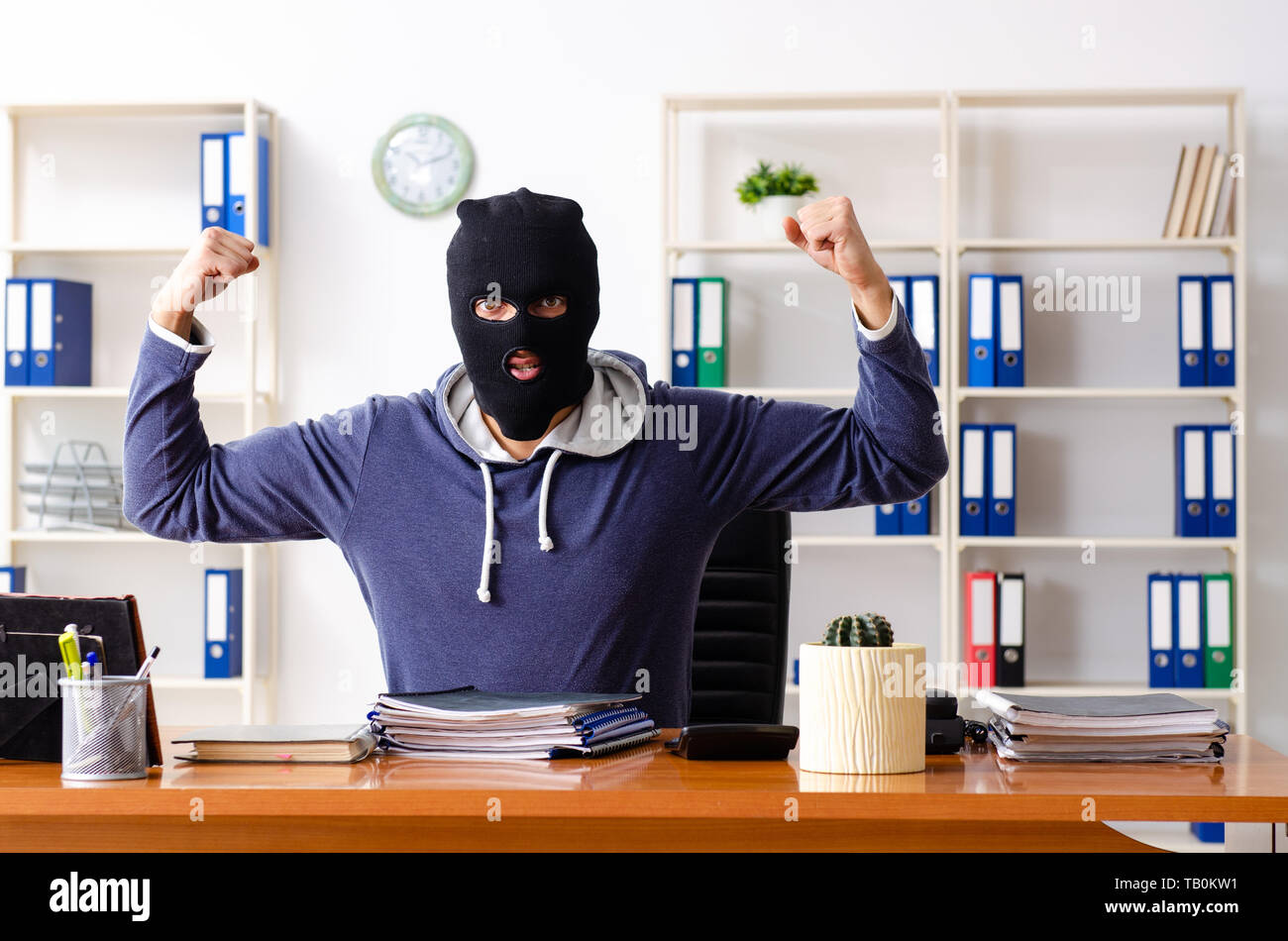 Male thief in balaclava in the office Stock Photo - Alamy
