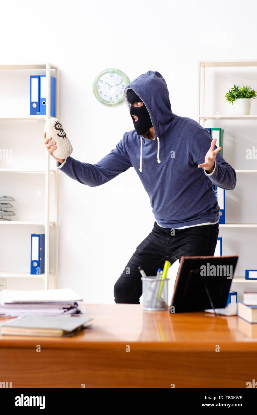 Male thief in balaclava in the office Stock Photo - Alamy
