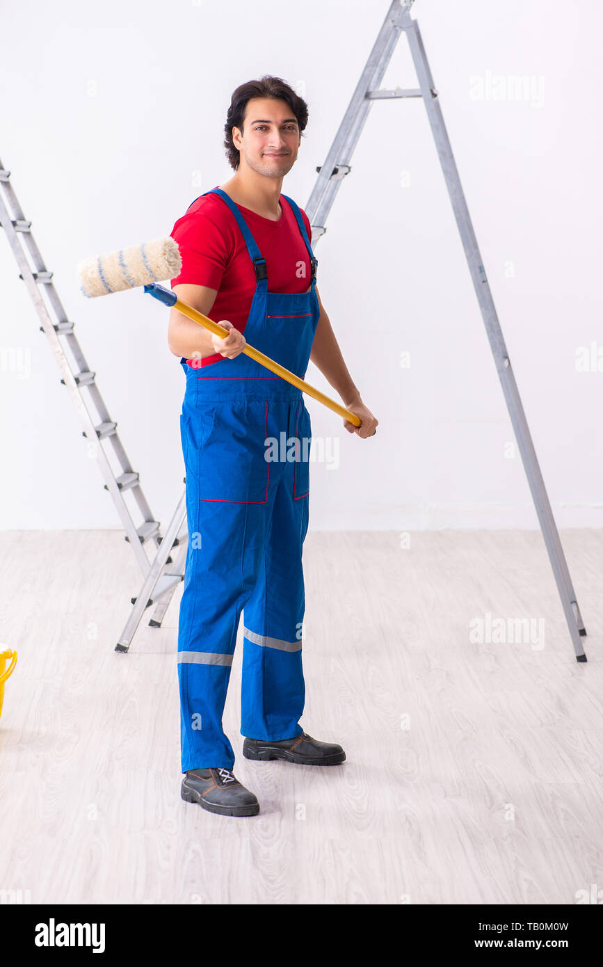 Young handsome contractor working indoors Stock Photo - Alamy