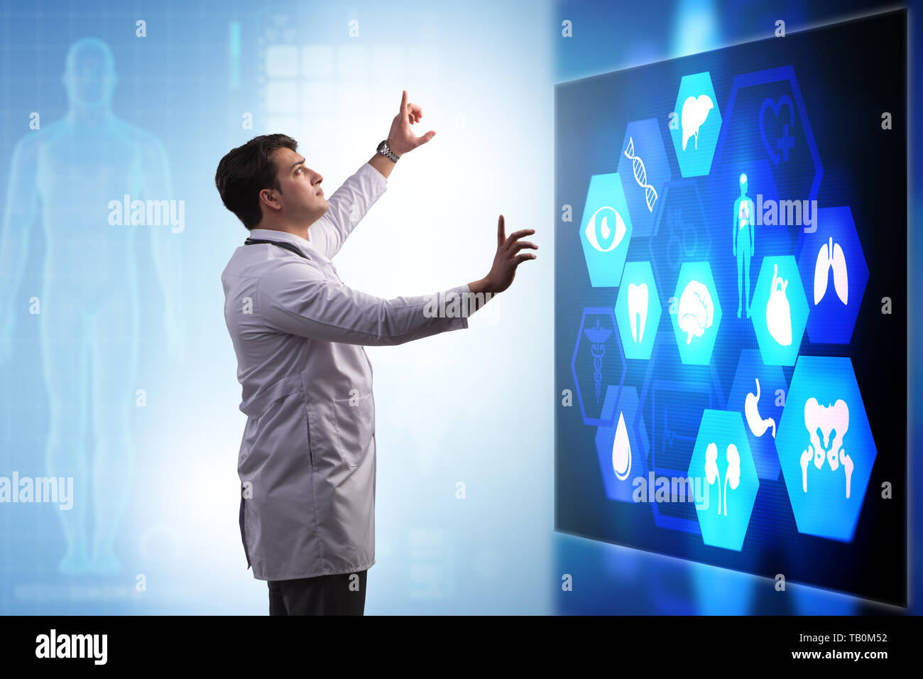 Doctor in telemedicine concept looking at screen Stock Photo - Alamy