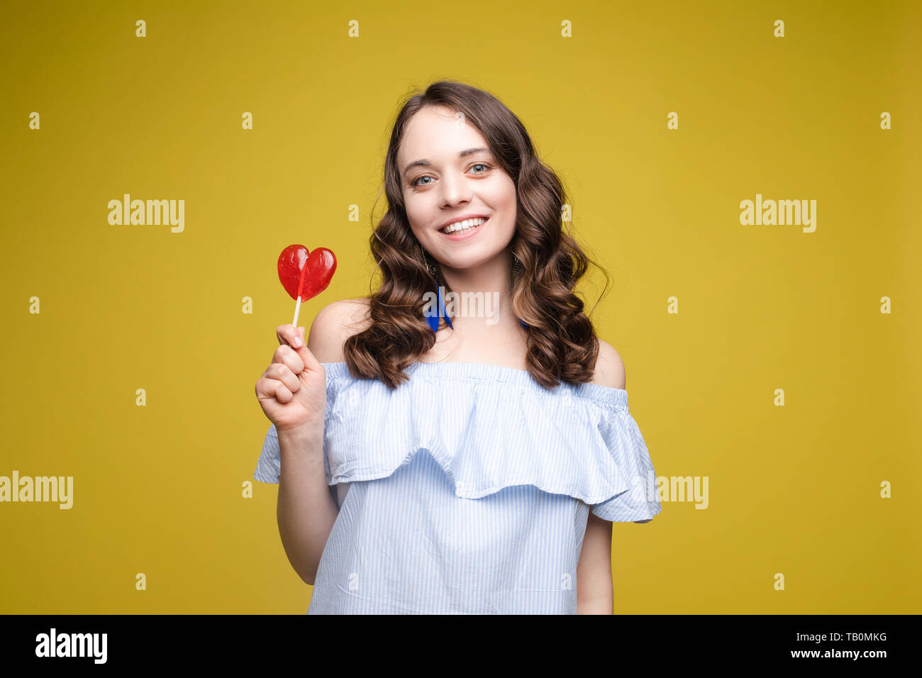 Beautiful and seductive woman wearing like sweet doll, posing at studio ...