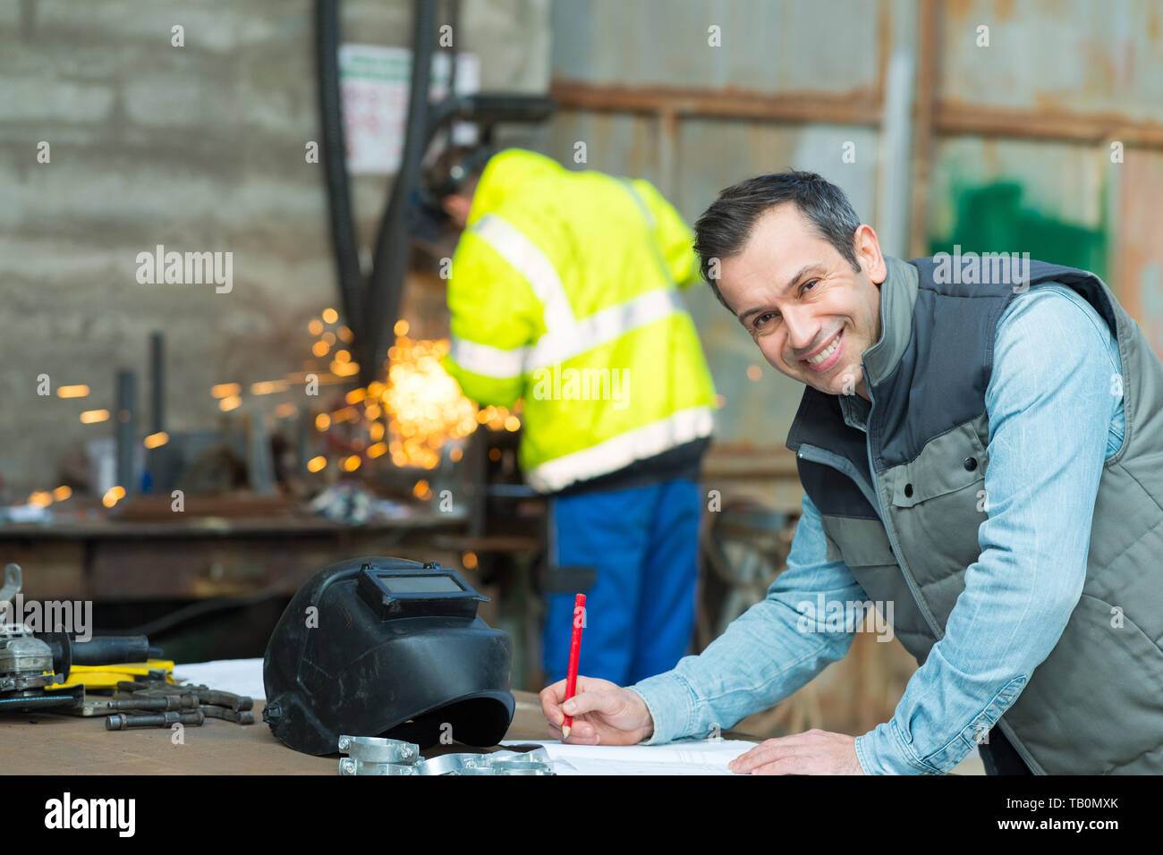happy industrial steel welder worker at factory workshop Stock Photo ...