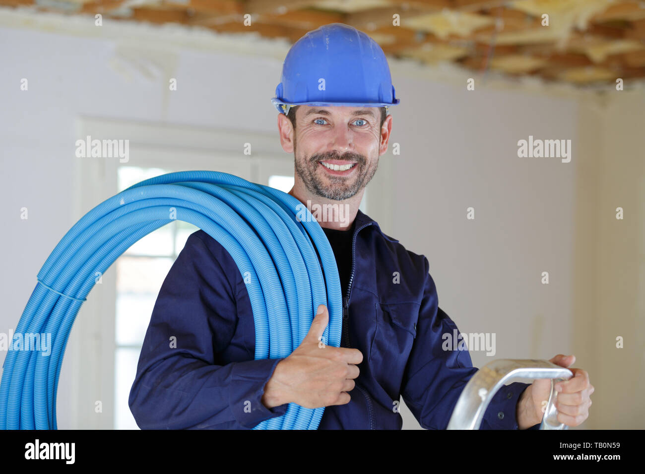 technician holding water pipes indoors Stock Photo - Alamy