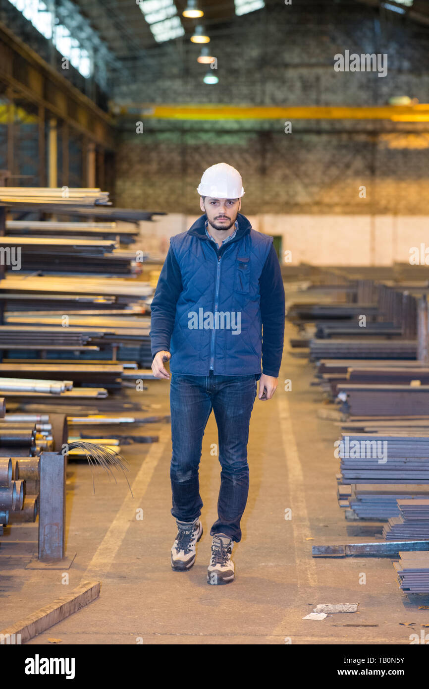 man walking in factory during construction Stock Photo - Alamy