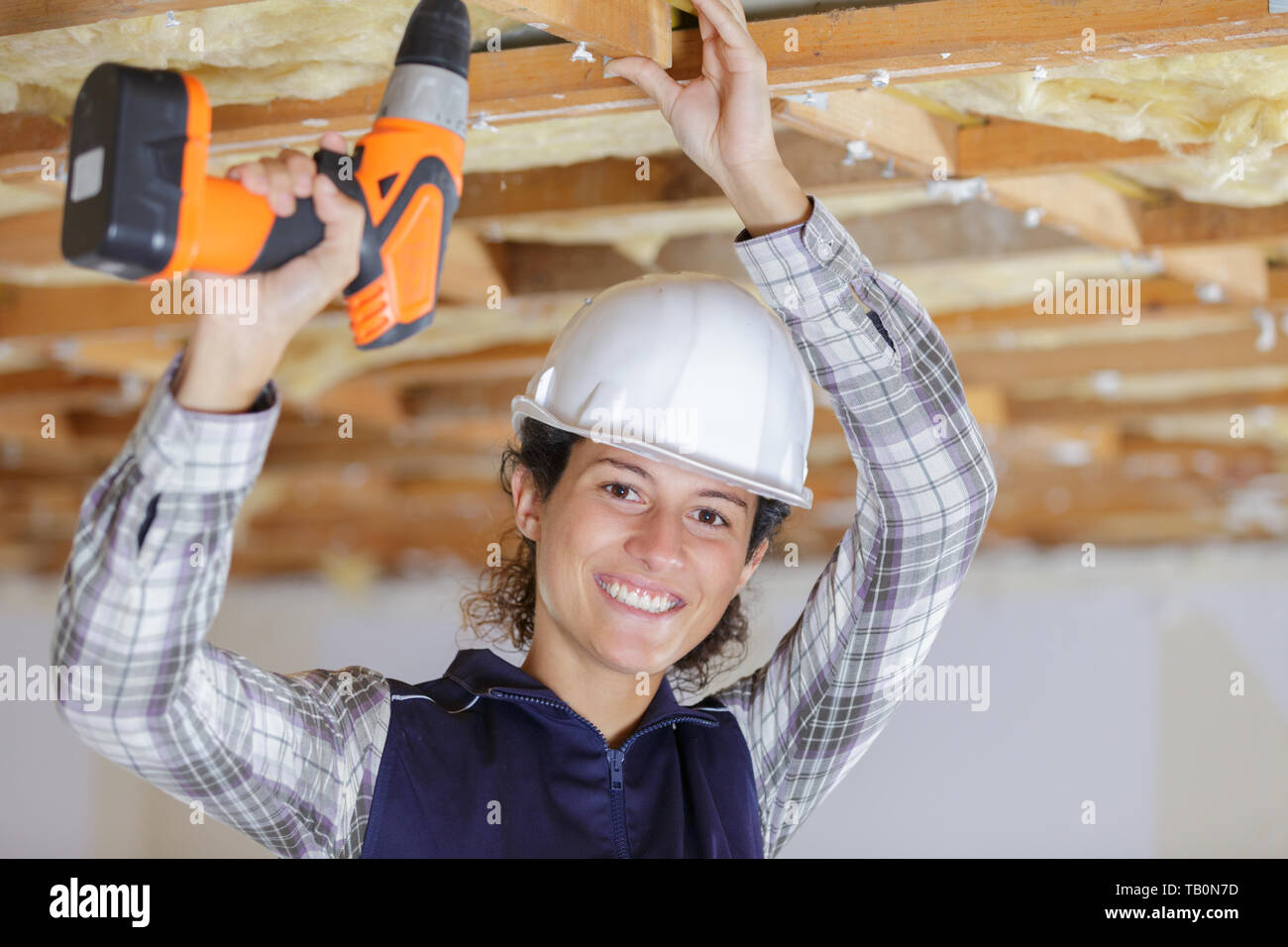 woman drilling the ceiling Stock Photo - Alamy