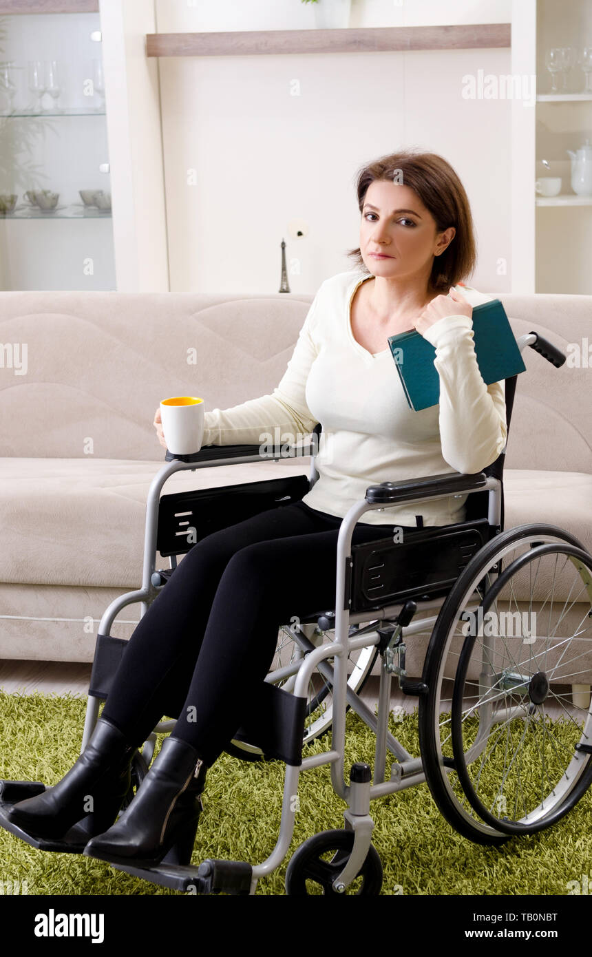 Woman in wheelchair at home Stock Photo - Alamy