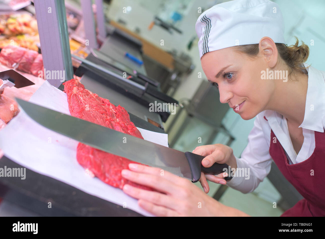 female butcher cutting meat Stock Photo - Alamy