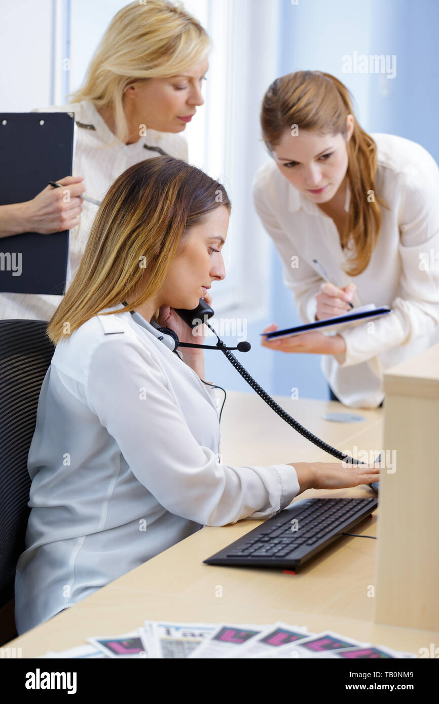casually dressed female colleagues talking during call Stock Photo - Alamy