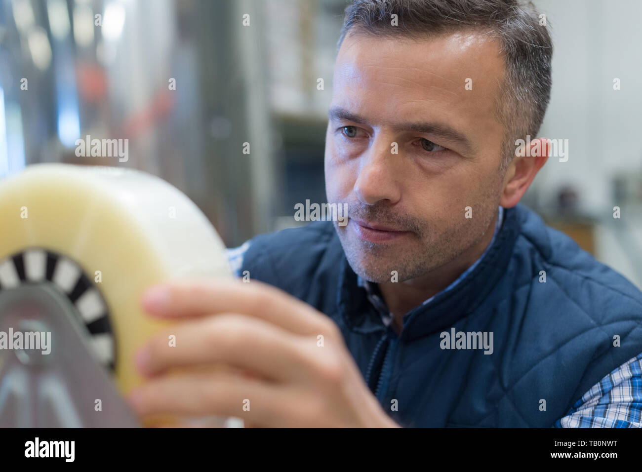 man checking cart wheel Stock Photo - Alamy