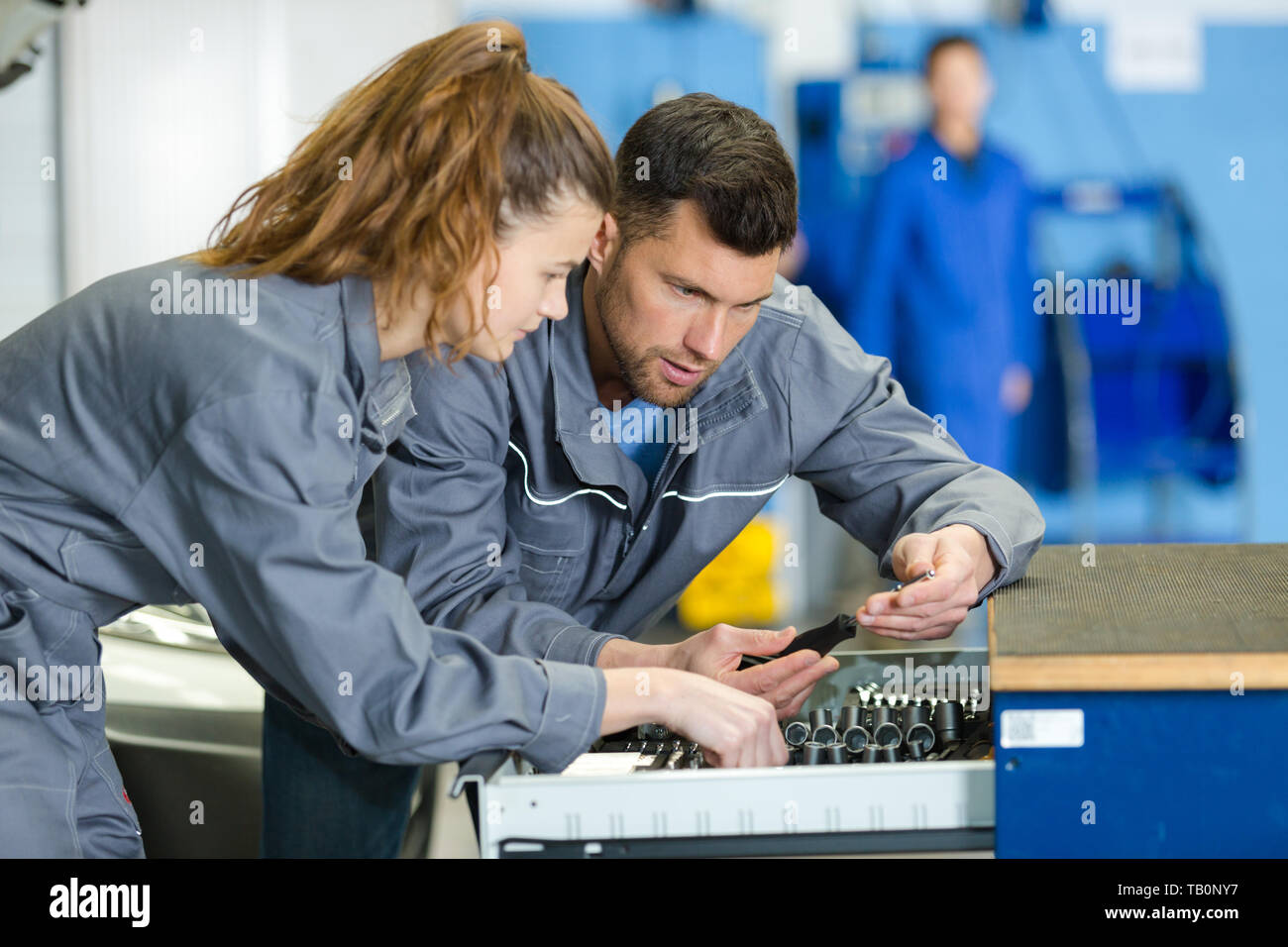 mechanic showing young female apprentice the tool drawer Stock Photo ...