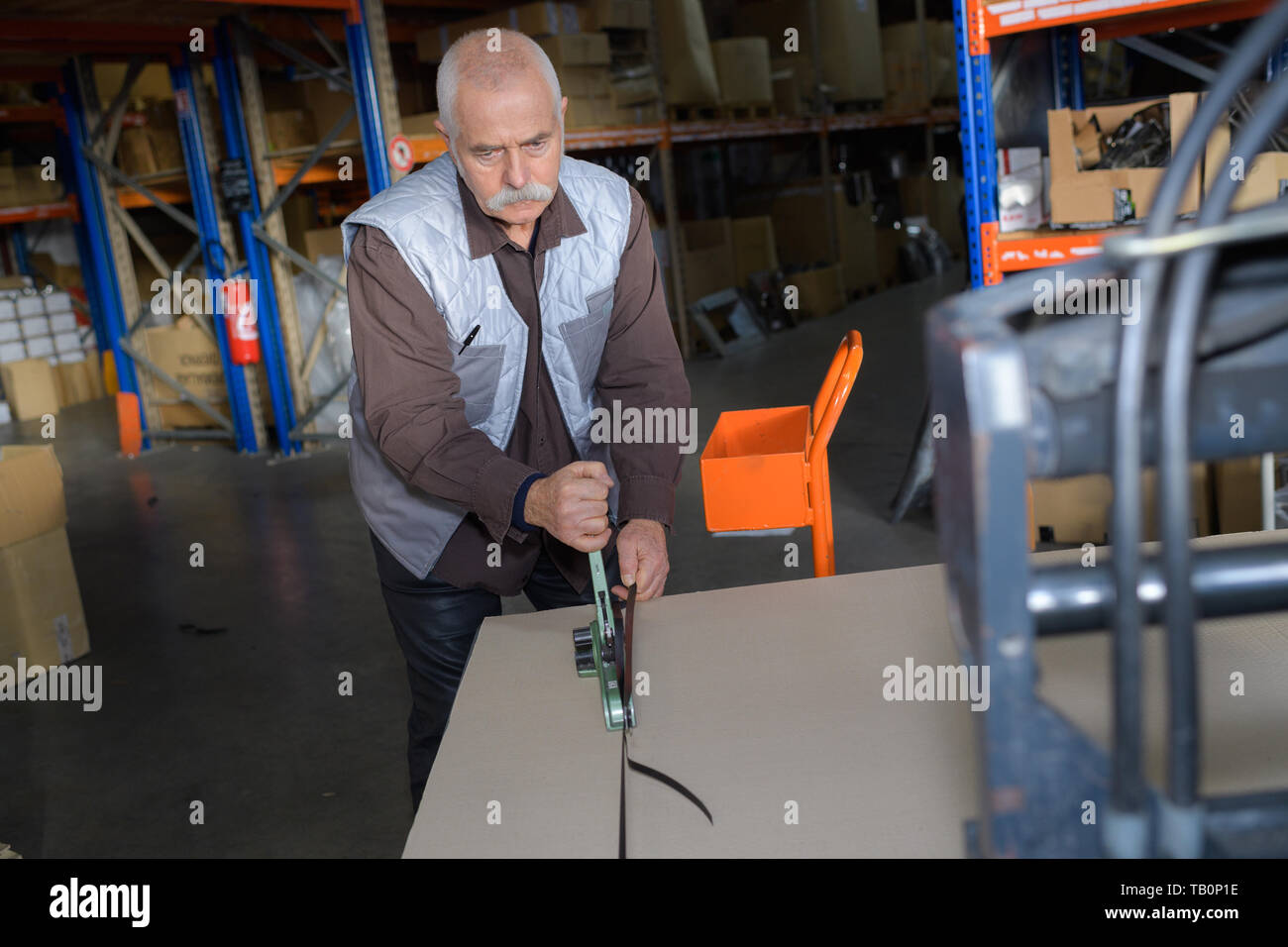 senior worker in warehouse Stock Photo - Alamy