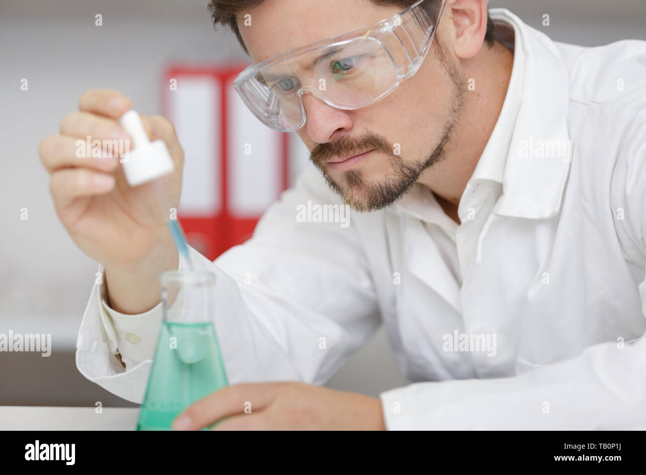 scientist looking at test-tube Stock Photo - Alamy