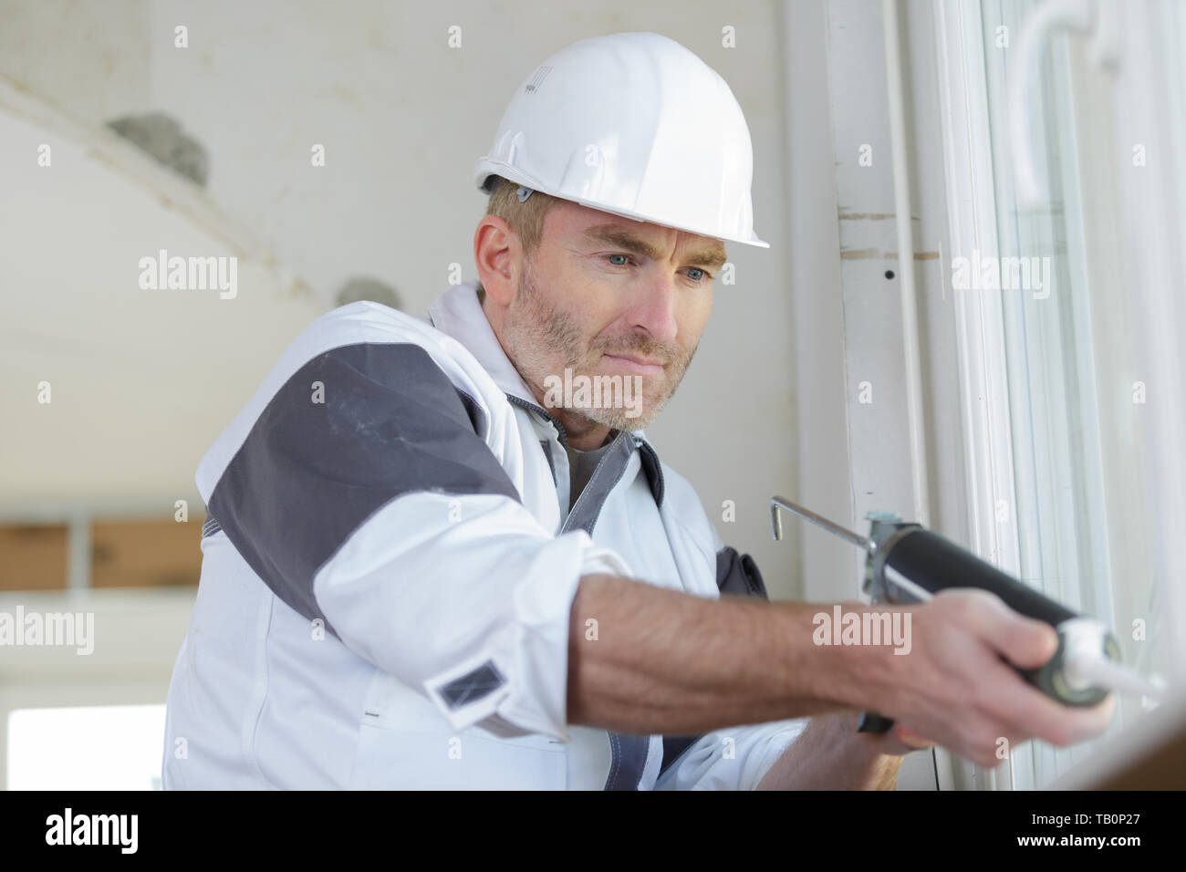 construction worker installing window in house Stock Photo - Alamy