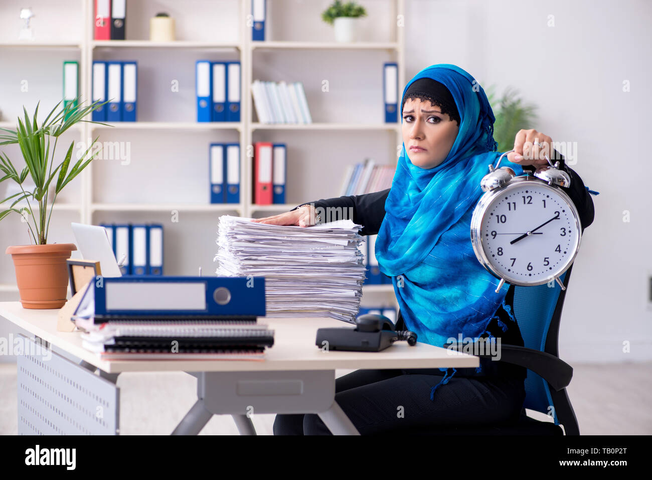 Female employee in hijab working in the office Stock Photo - Alamy