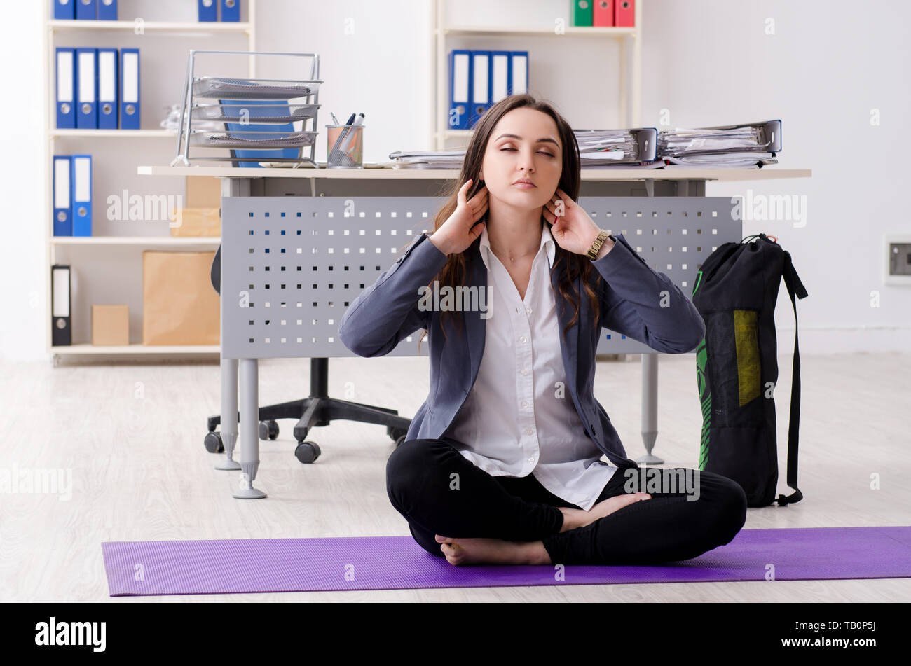 Female employee doing sport exercises in the office Stock Photo - Alamy