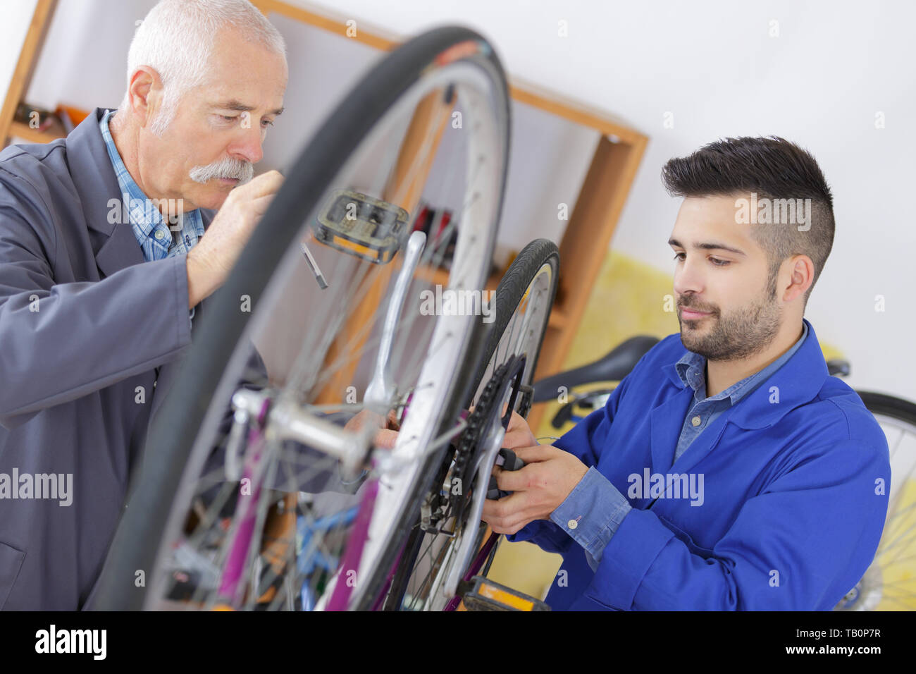 Mechanic working on bicycle hi-res stock photography and images - Alamy