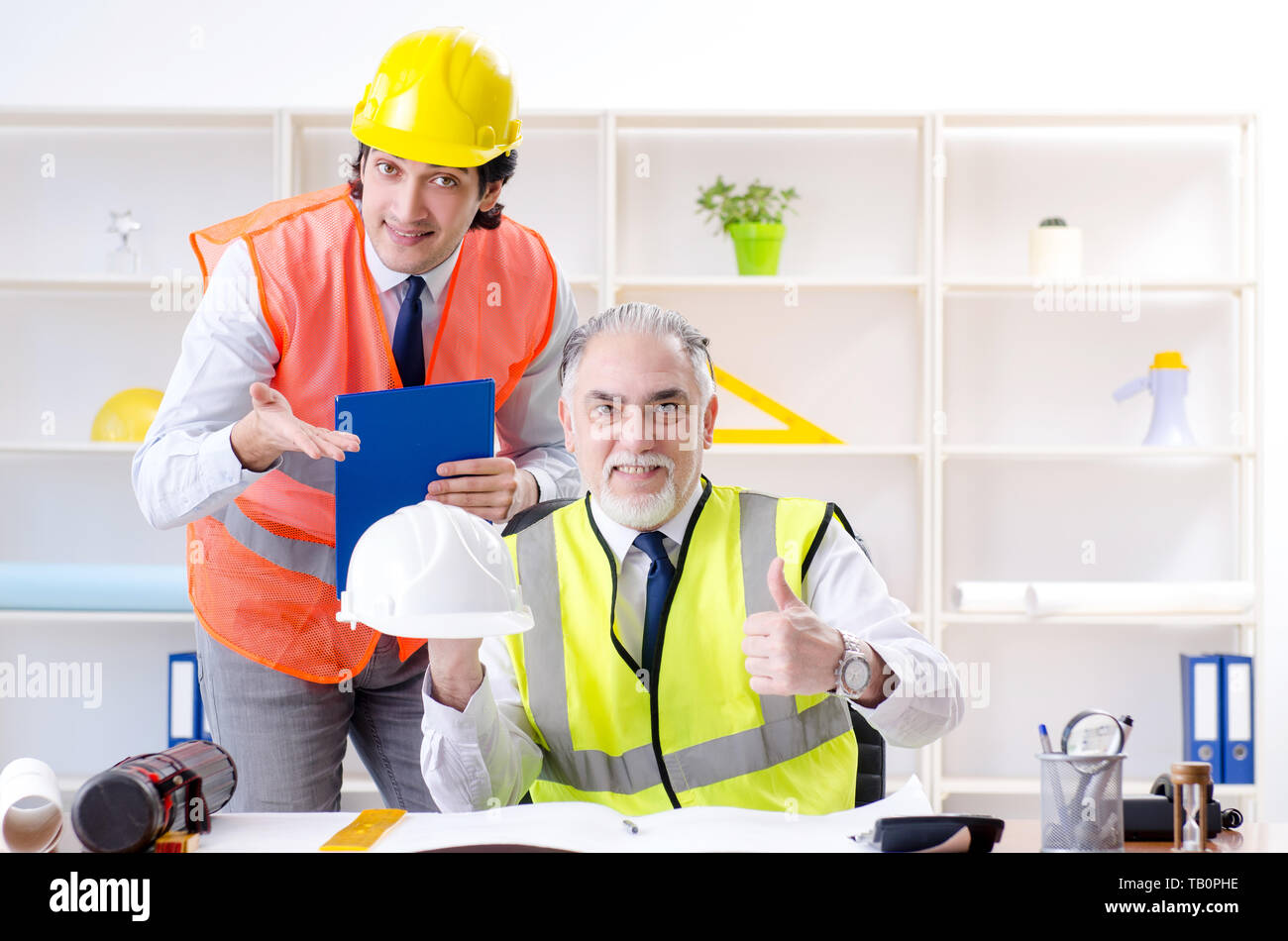 Two engineers colleagues working under project Stock Photo - Alamy