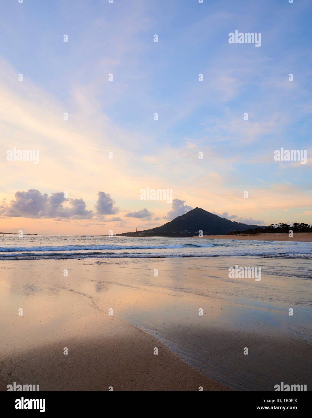 Beach of moledo at the end of the day, with a view to trega mountain on ...