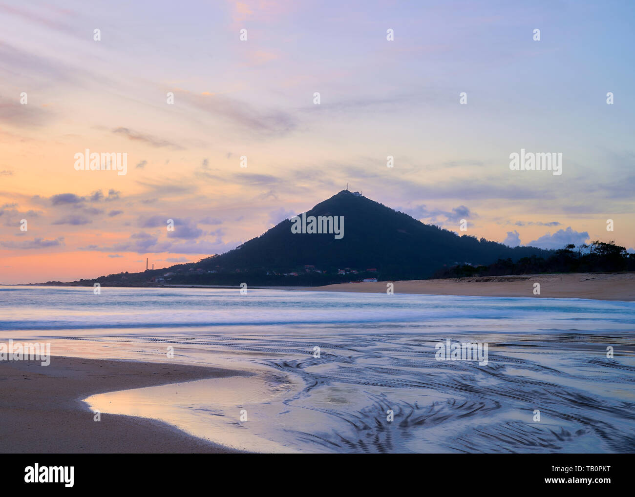 Beach of moledo at the end of the day, with a view to trega mountain on ...