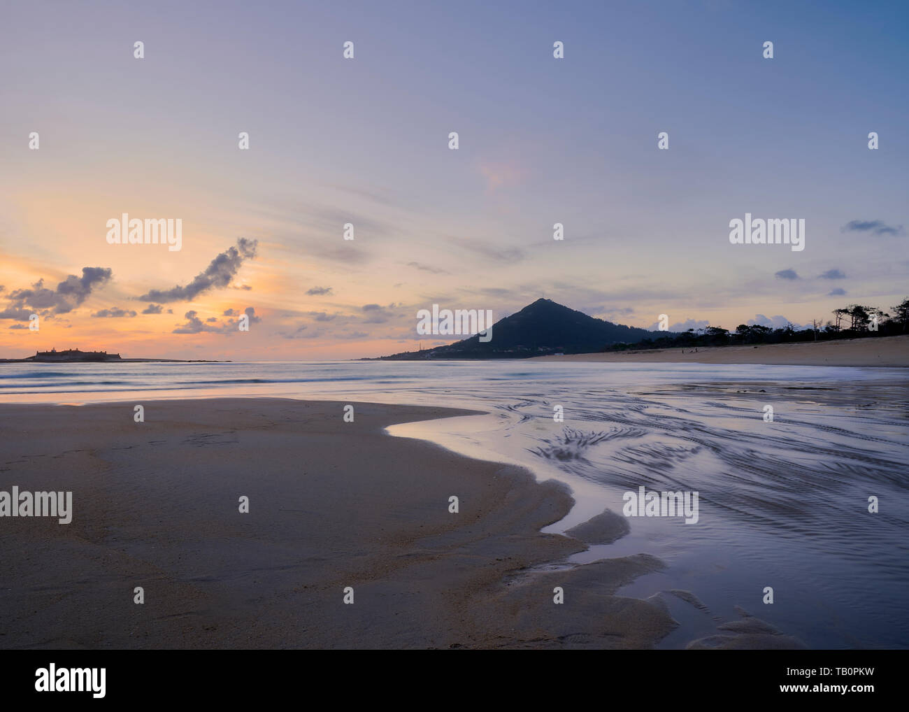 Beach of moledo at the end of the day, with a view to trega mountain on ...