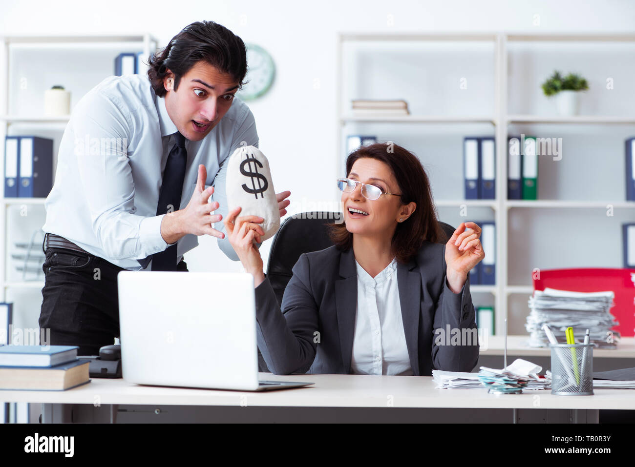 Old female boss and young male employee in the office Stock Photo - Alamy