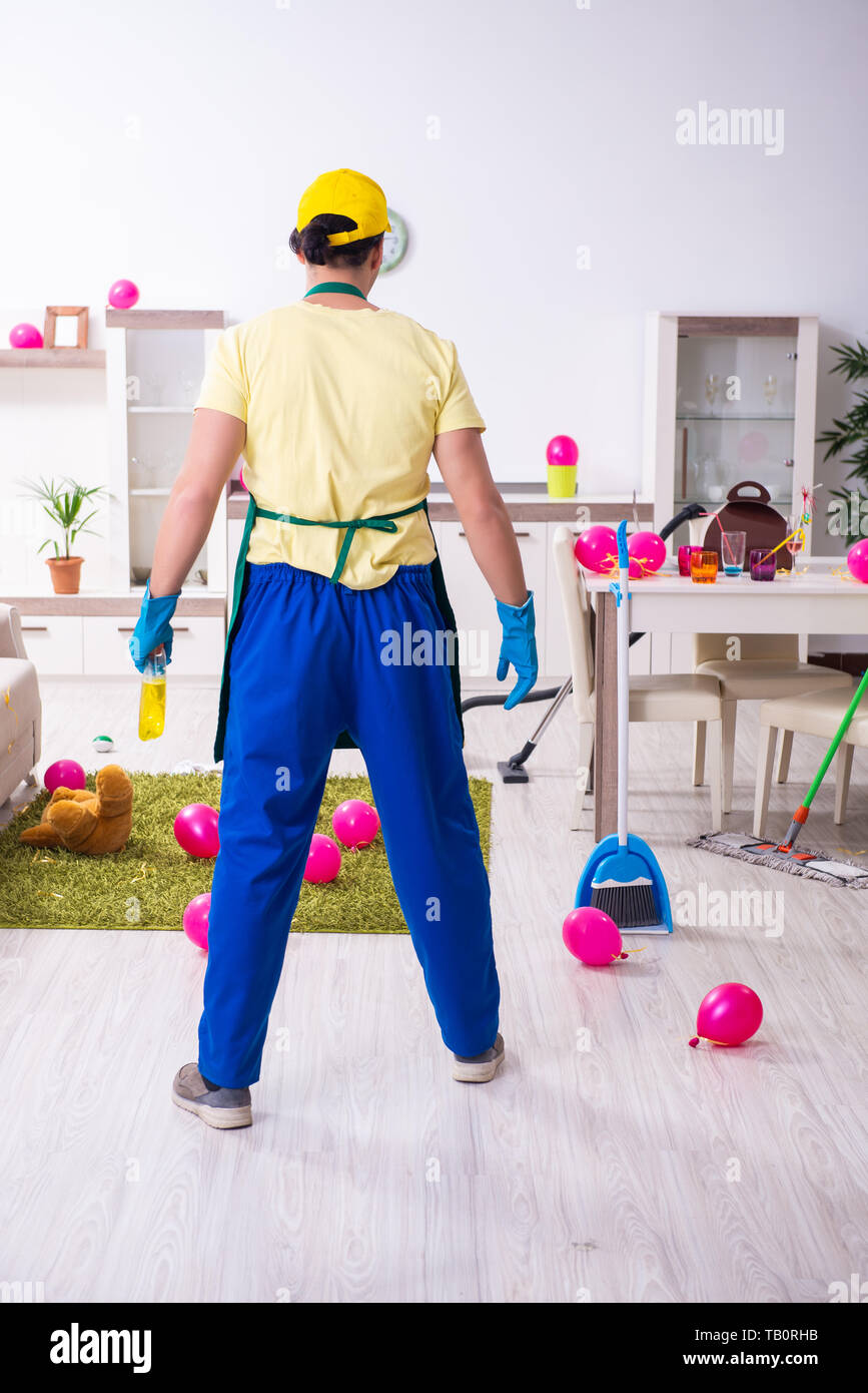 The young male contractor doing housework after party Stock Photo - Alamy