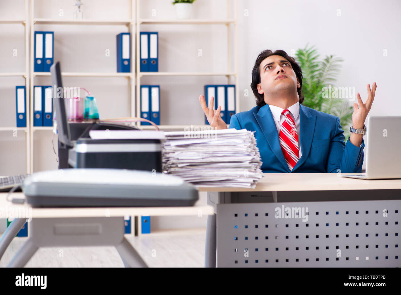 Young employee making copies at copying machine Stock Photo - Alamy