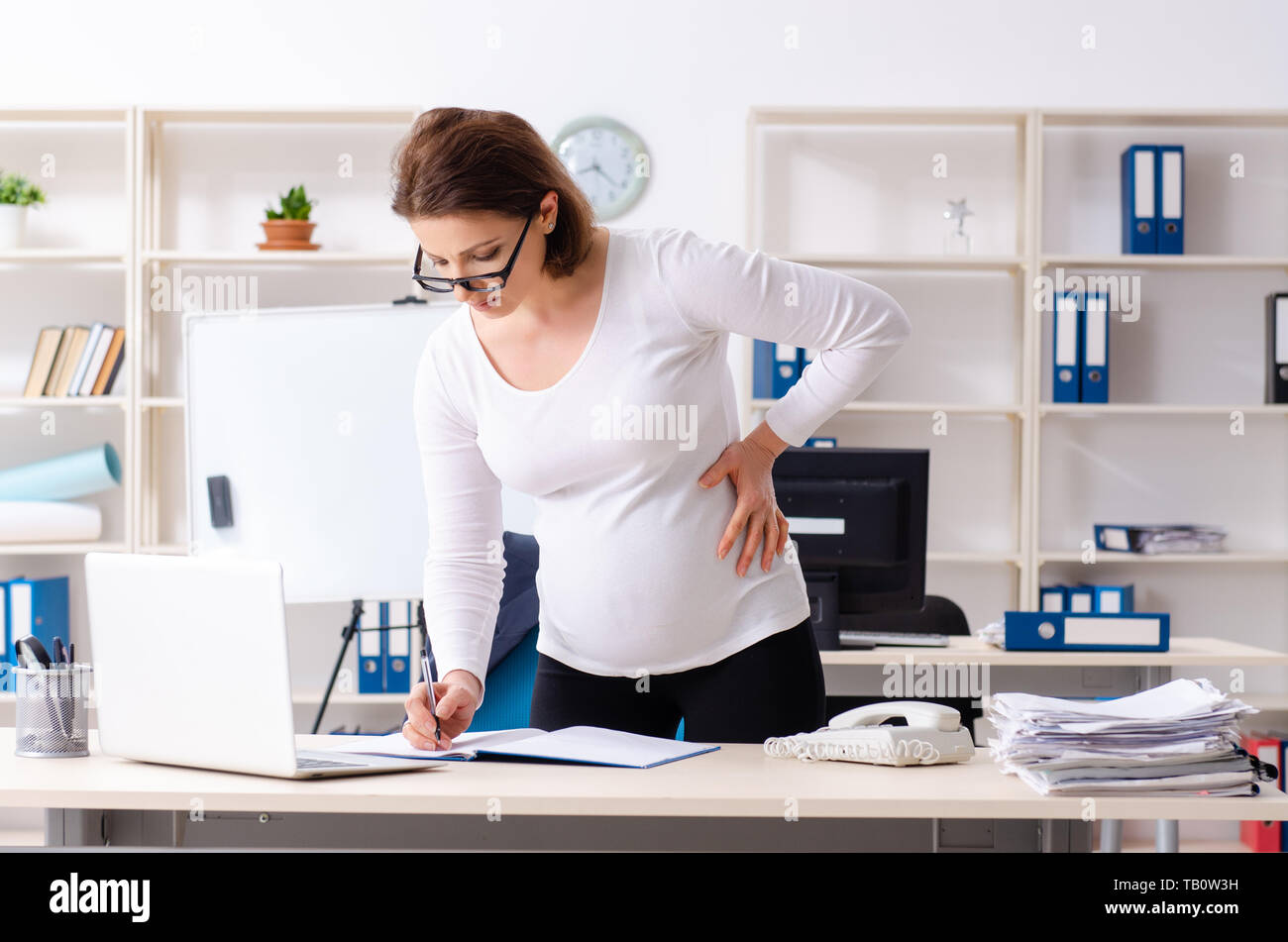 Experienced female employee working in the office Stock Photo - Alamy