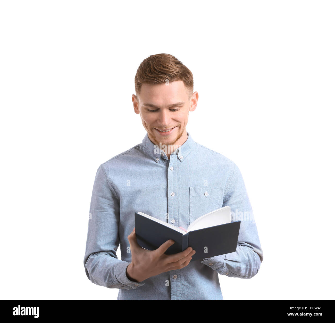 Handsome young man with book on white background Stock Photo - Alamy