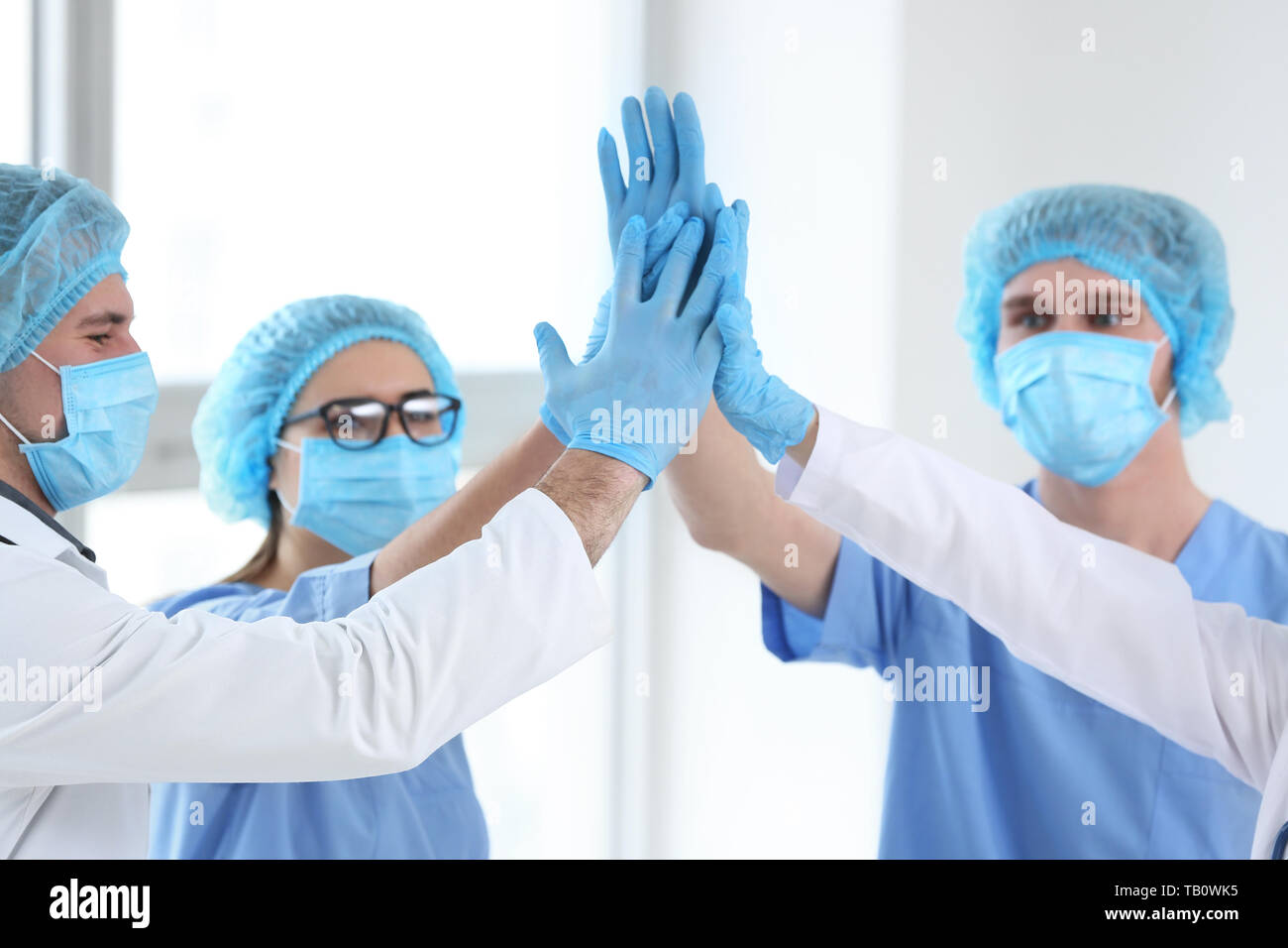 Doctors giving high five team hi-res stock photography and images - Alamy