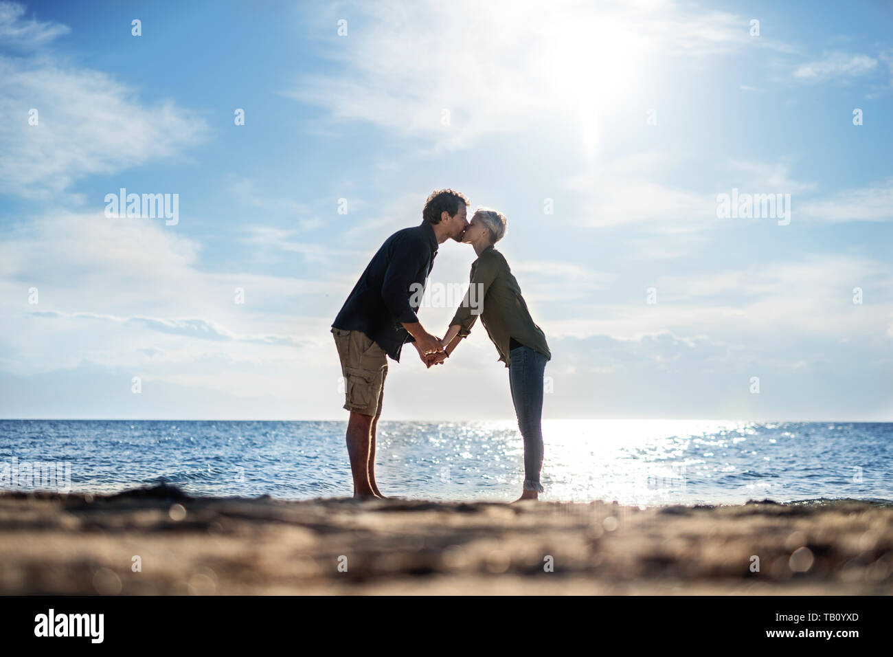 Couple kissing on empty beach hi-res stock photography and images - Alamy