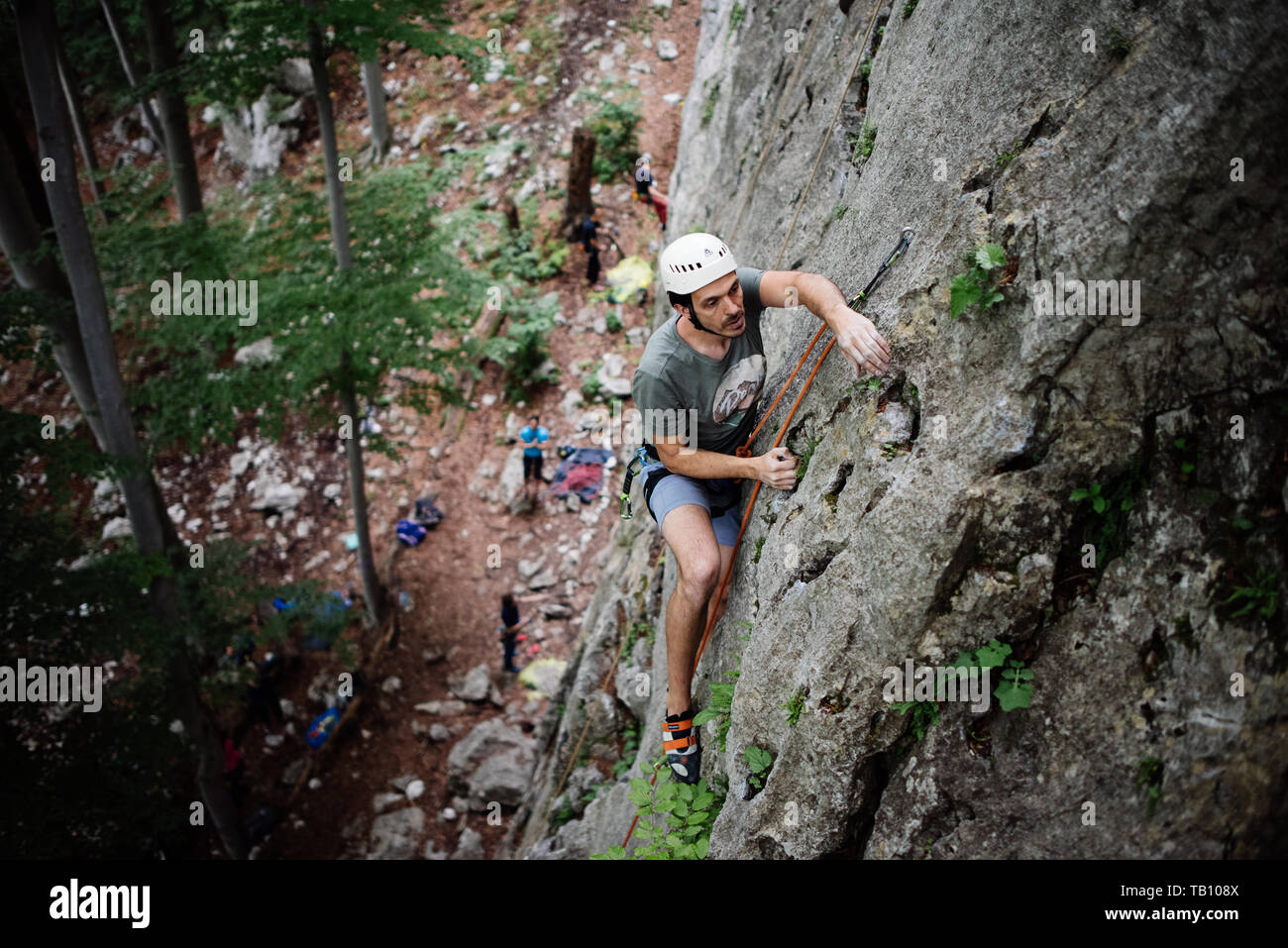 Strong man climbing outside on a mountain Stock Photo - Alamy