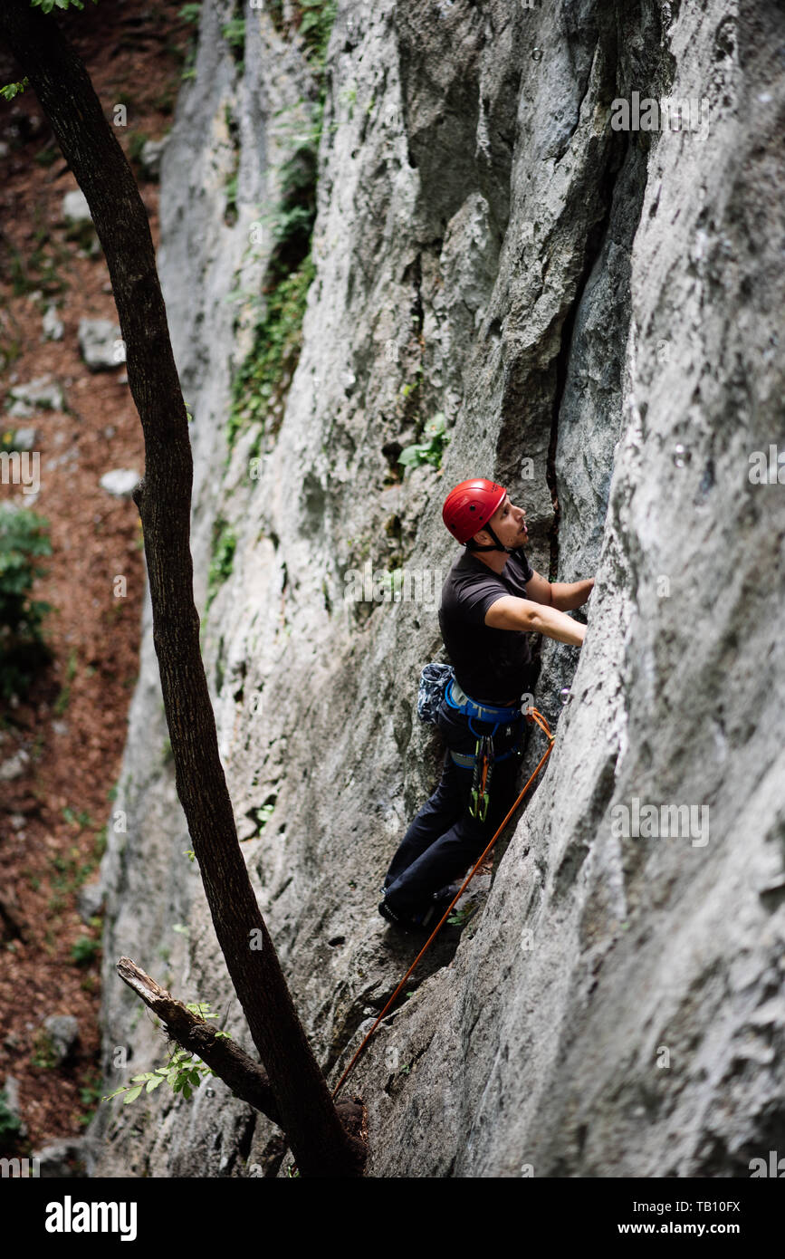 Strong man climbing outside on a mountain Stock Photo - Alamy