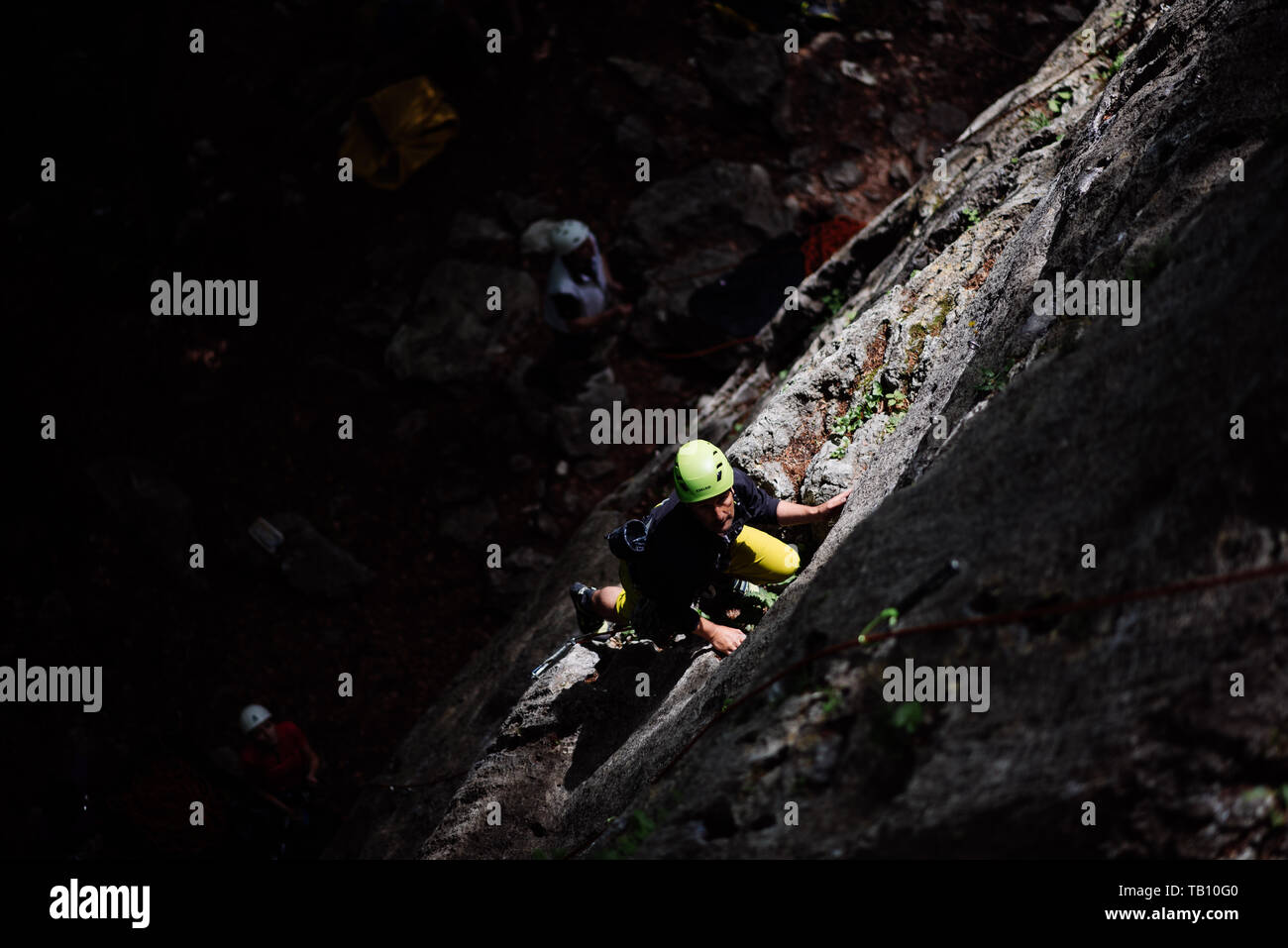 Strong man climbing outside on a mountain Stock Photo - Alamy