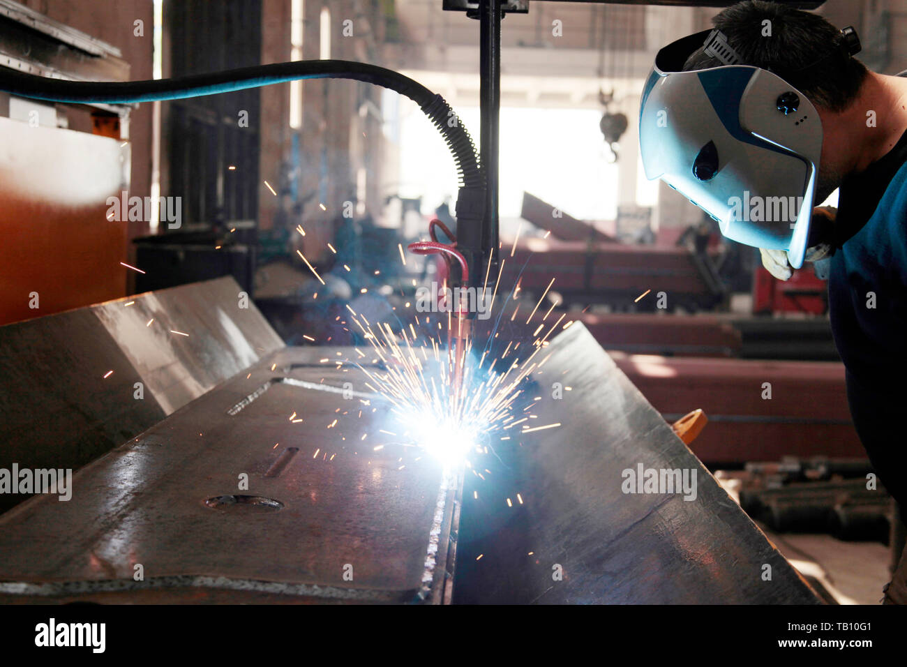 Worker and cnc machine Stock Photo - Alamy