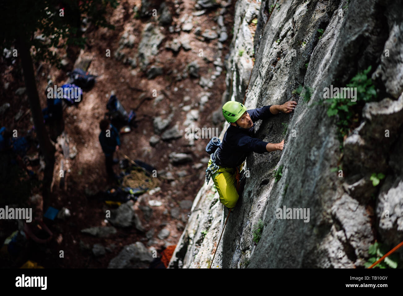 Strong man climbing outside on a mountain Stock Photo - Alamy