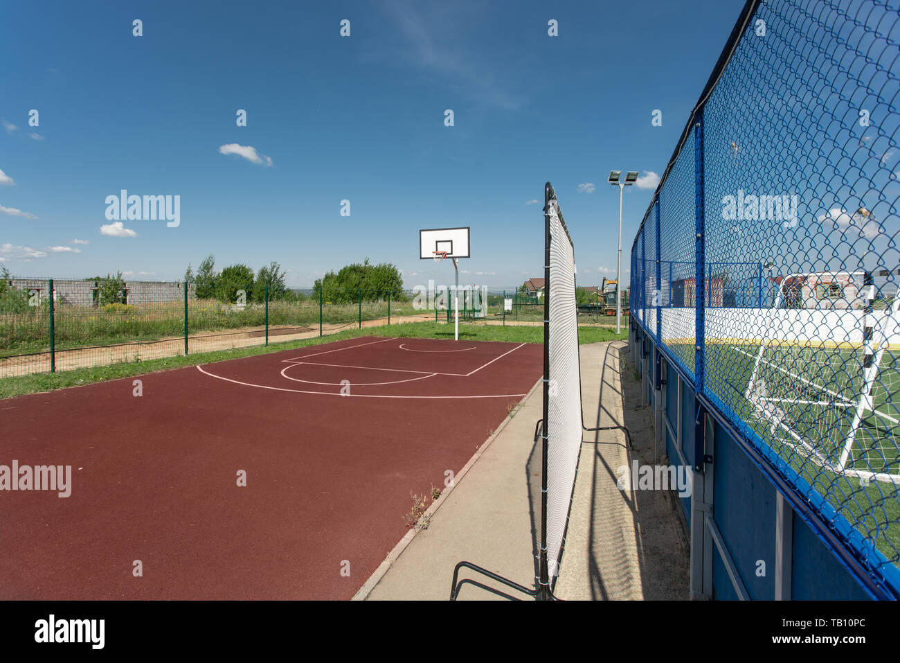 Basketball structure in an outdoor playground surrounded by trees in a ...
