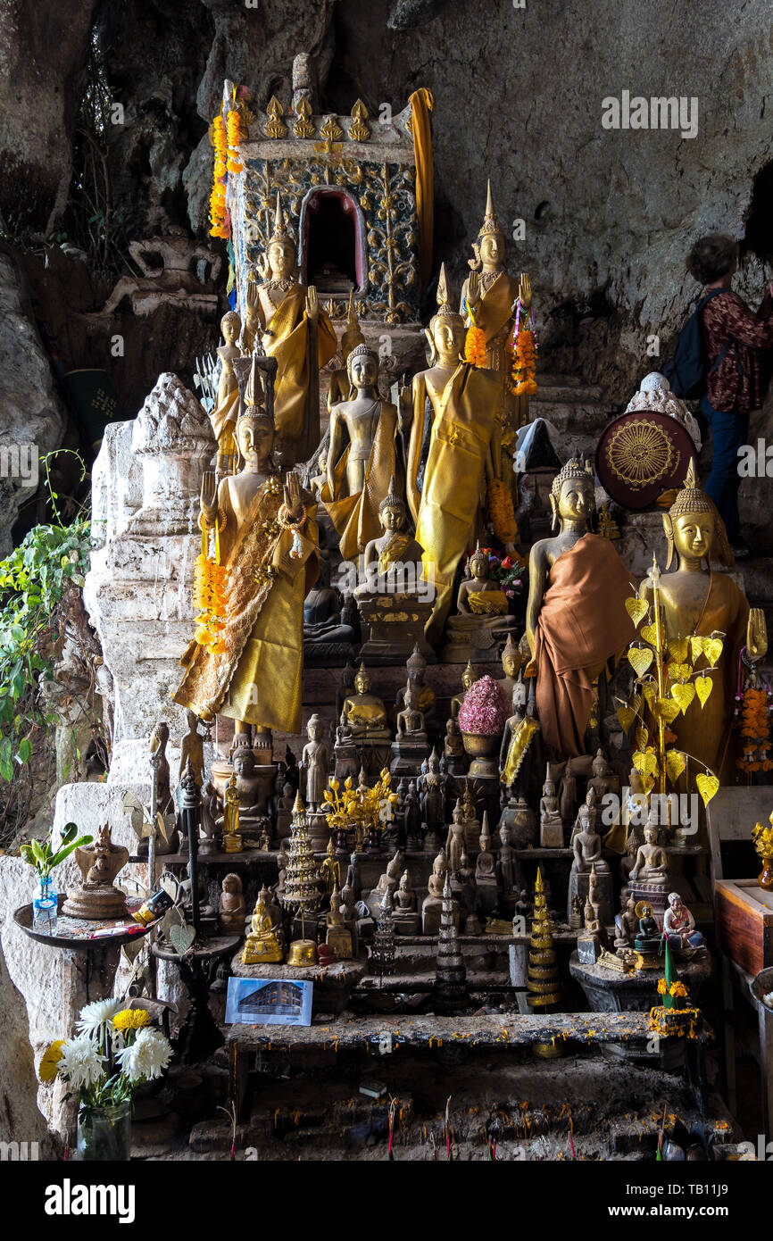 Hundreds of old and faded Buddha statues inside the Tham Ting Cave at ...