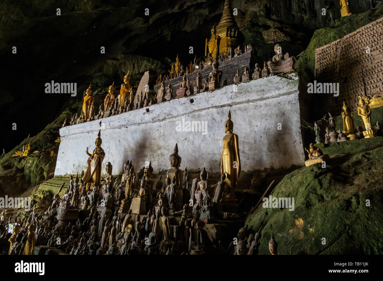 Hundreds of old and faded Buddha statues inside the Tham Ting Cave at ...