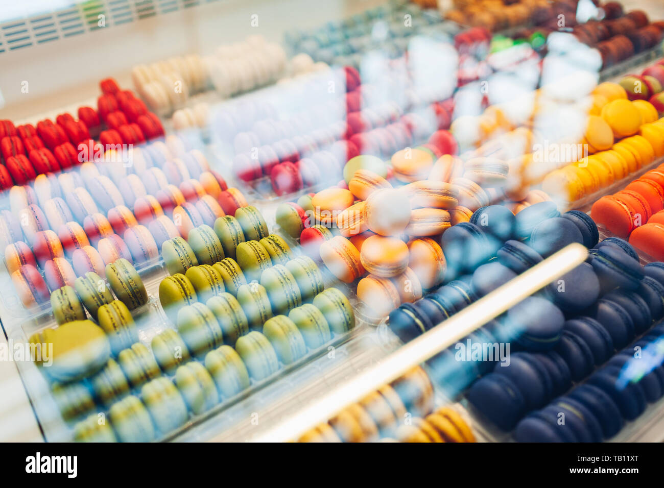 Assortment of colorful macaroons on cafe showcase. Variety of macaron ...