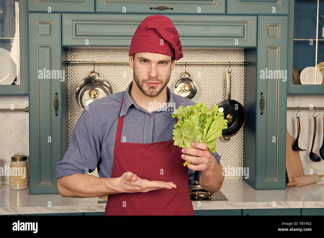 Man chef wear apron cooking kitchen. Man cook vegetarian recipe with ...