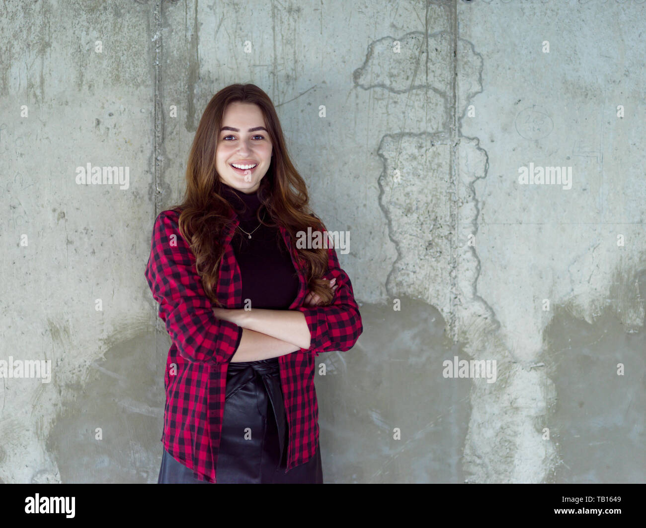Portrait Of Young Female Architect On Construction Site While Checking Documents And Business