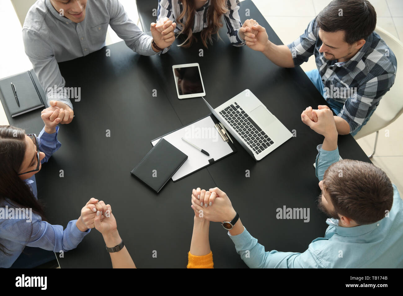 Group of people praying before meeting in office Stock Photo - Alamy