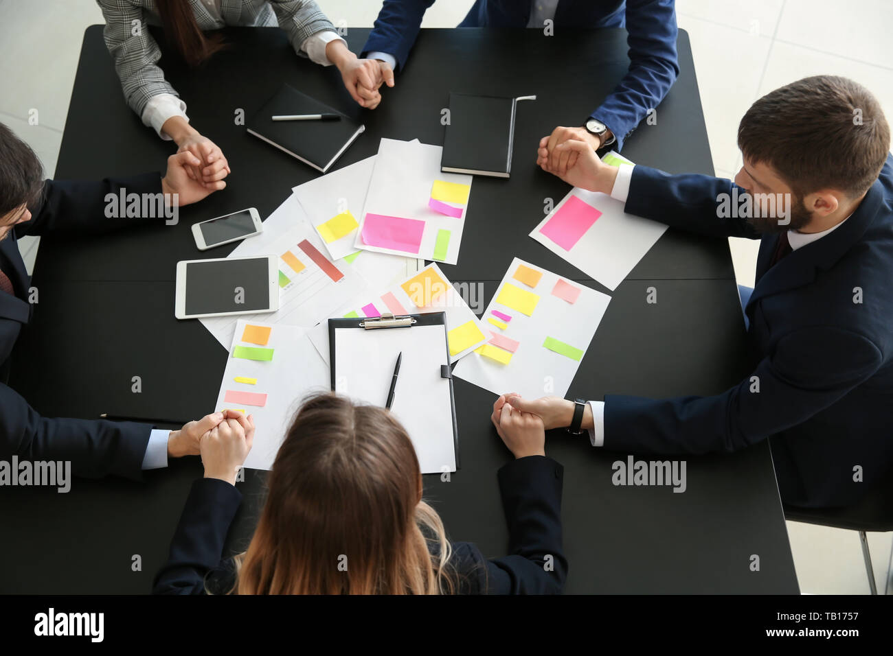 Group of people praying before meeting in office Stock Photo - Alamy