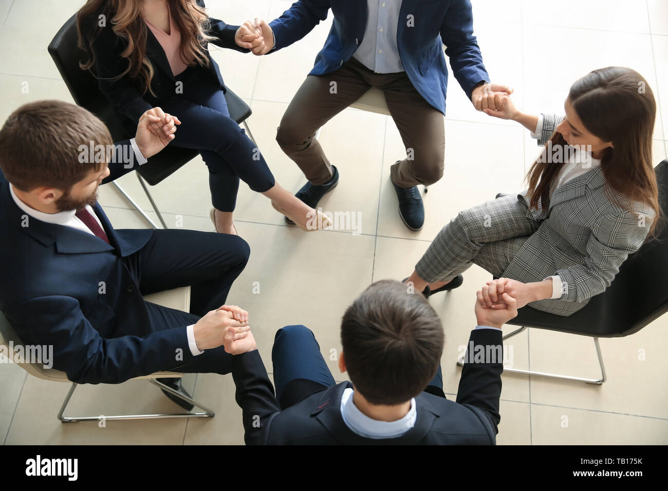 Group of people praying before meeting in office Stock Photo - Alamy
