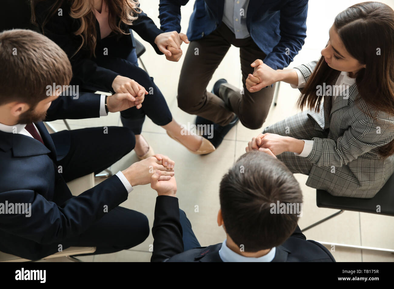 Group of people praying before meeting in office Stock Photo - Alamy